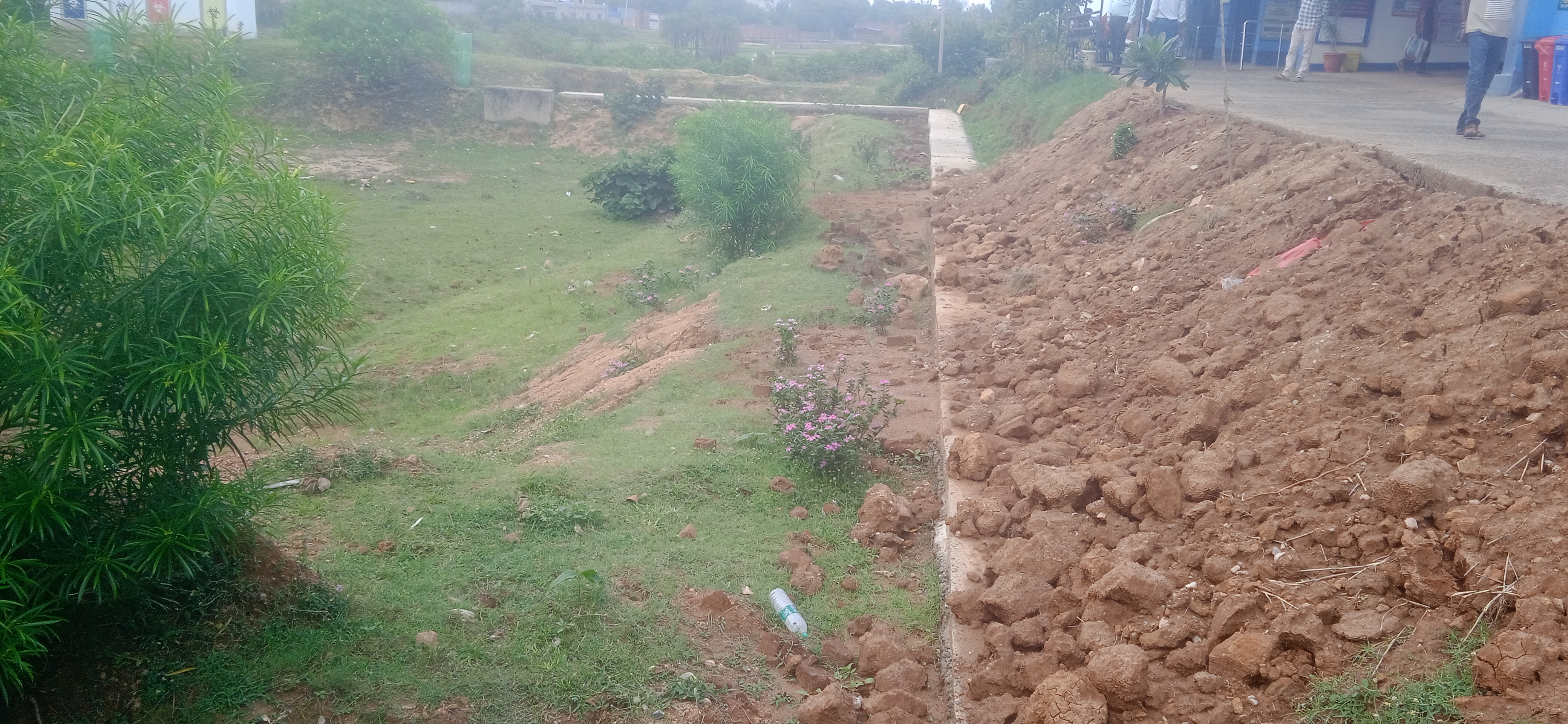 Incomplete guard wall in front of the hospital gate, danger persists