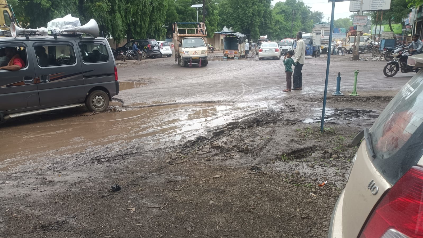Formation of pond due to water accumulation in pit on the main road in ...
