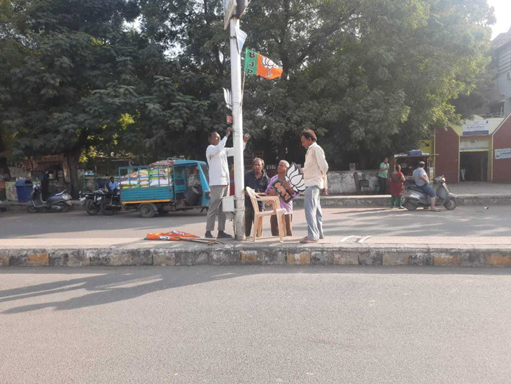 In Adipur, party flags were taken down from poles violating the code of ...