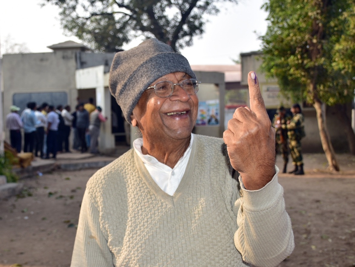 Tribhuvan Patel, an 82-year-old senior voter from Karamsad, reached to ...