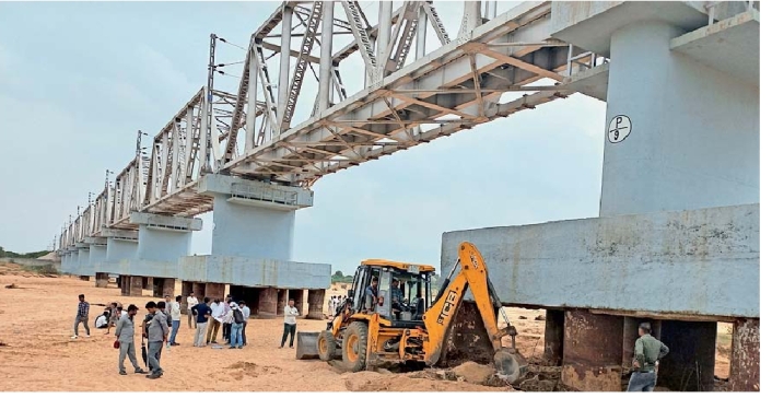 Drilling into the pillars of railway bridge over Kamboi Banas river and ...