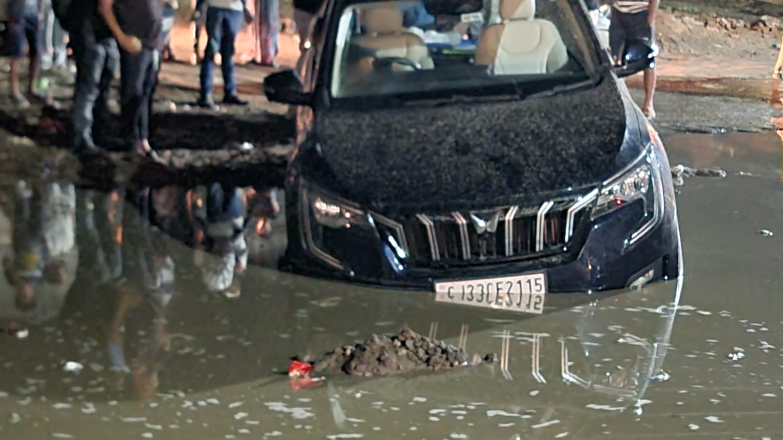 People outraged as cars fall into pothole in rain behind Anand Vaibhav ...