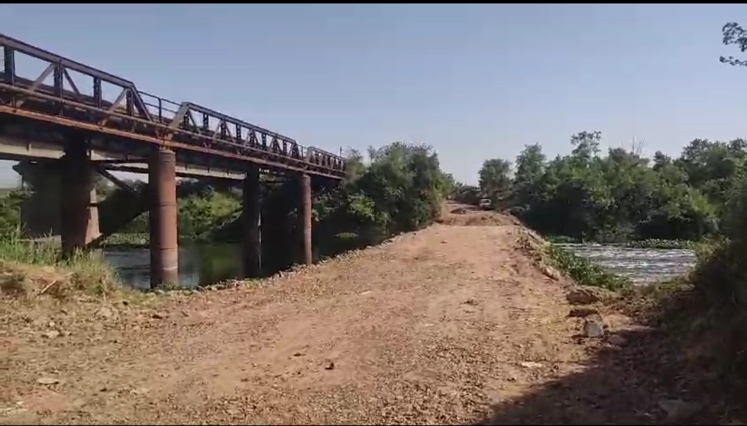 A temporary bridge was constructed over Dhadhar river to pass machinery ...